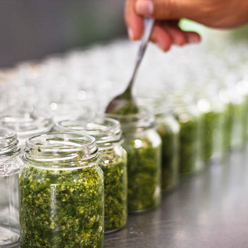 Integrity - Person carefully preparing food in jars